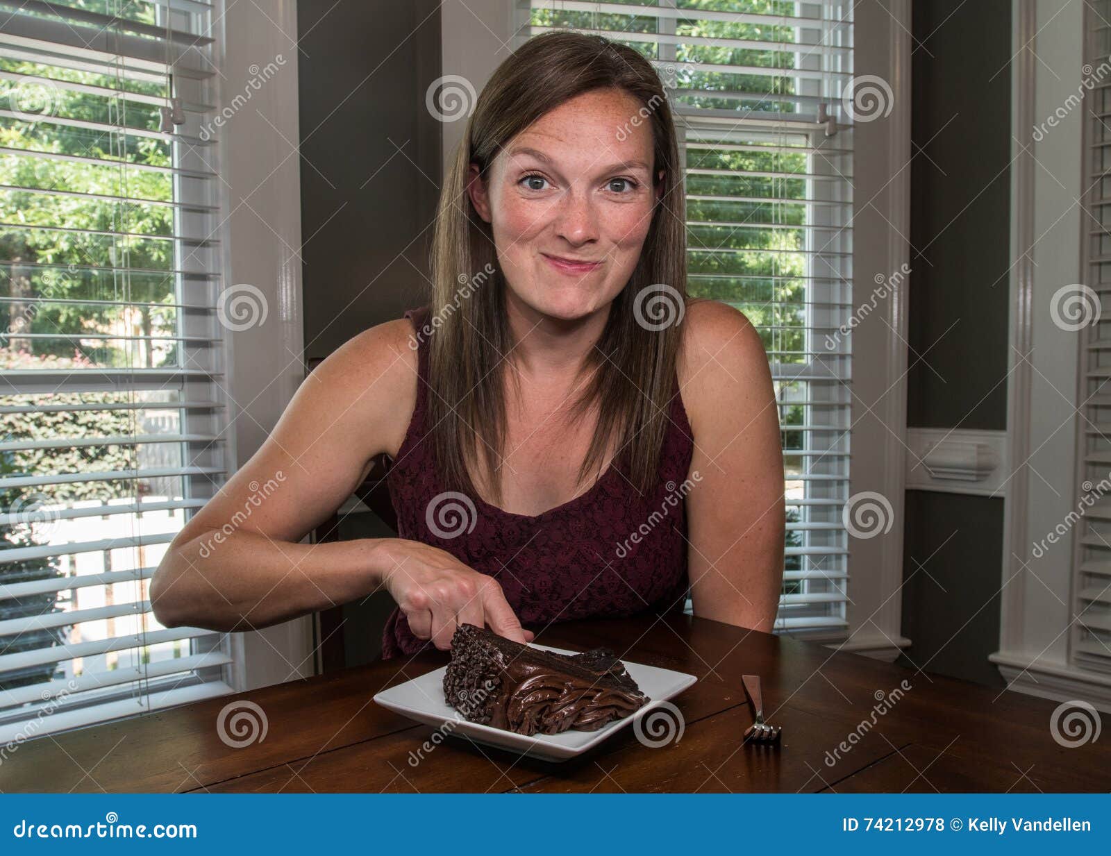 Woman Smirking at Camera while Pulling Chocolate Cake Stock Photo ...