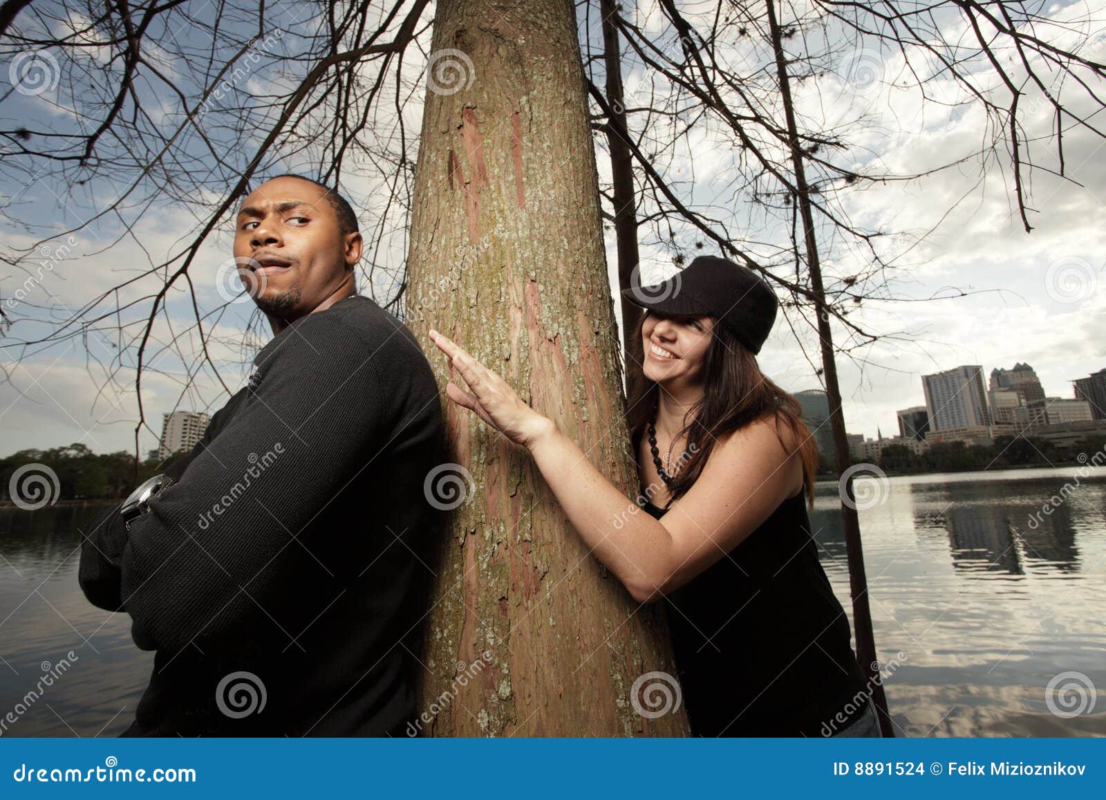 Woman sneaking up on a man stock photo. Image of american - 8891524