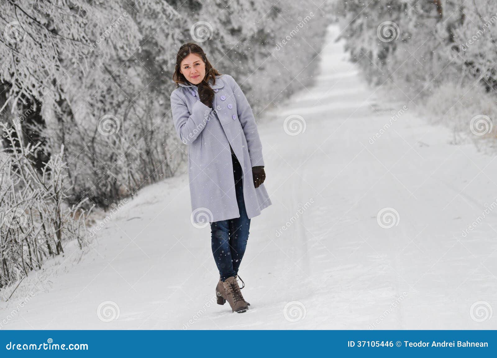 Woman on snow covered road stock photo. Image of female - 37105446