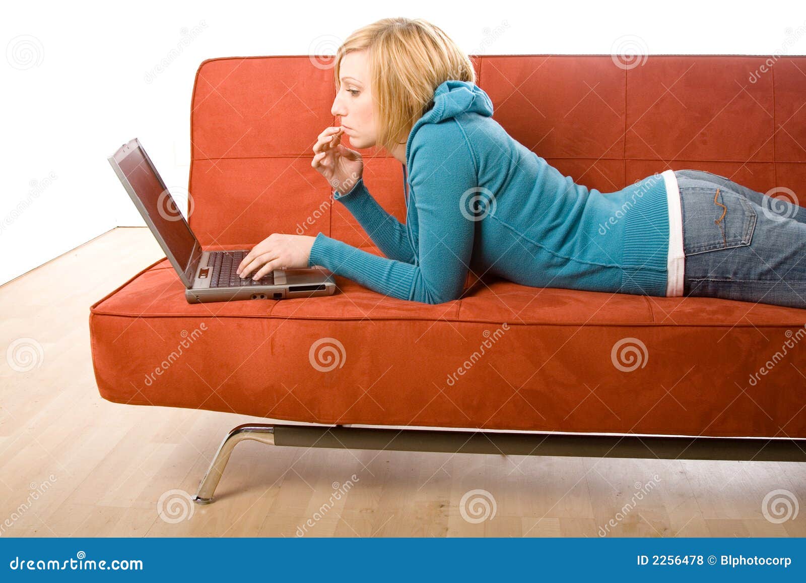 Woman on Sofa with Laptop stock photo. Image of looking - 2256478