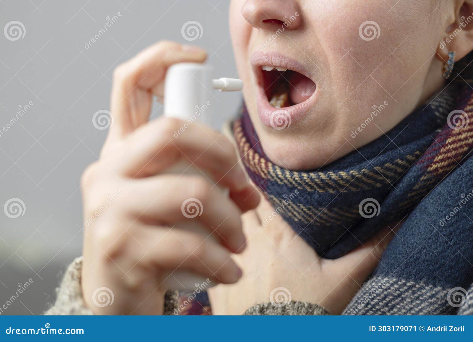 A Woman With A Sore Throat Sprays Medicine Aerosol Spray Down Her