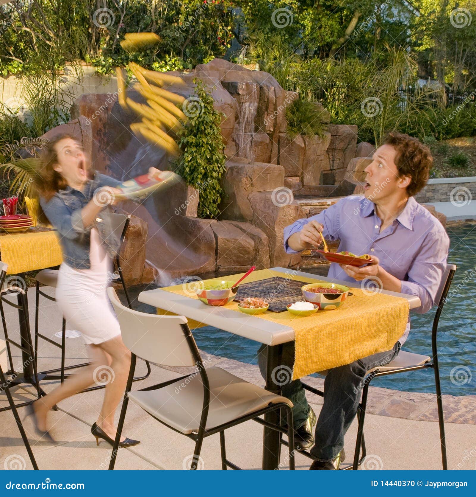 Woman Spilling Her Food At Poolside Stock Photo - Image: 14440370