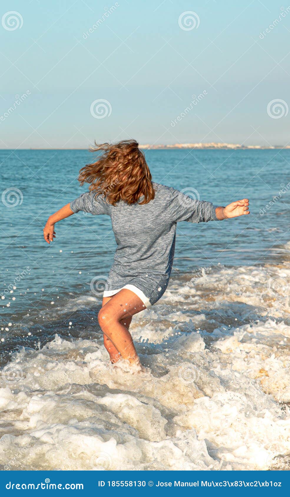 Woman Splashed and Surprised by a Wave on the Beach Stock Photo - Image ...
