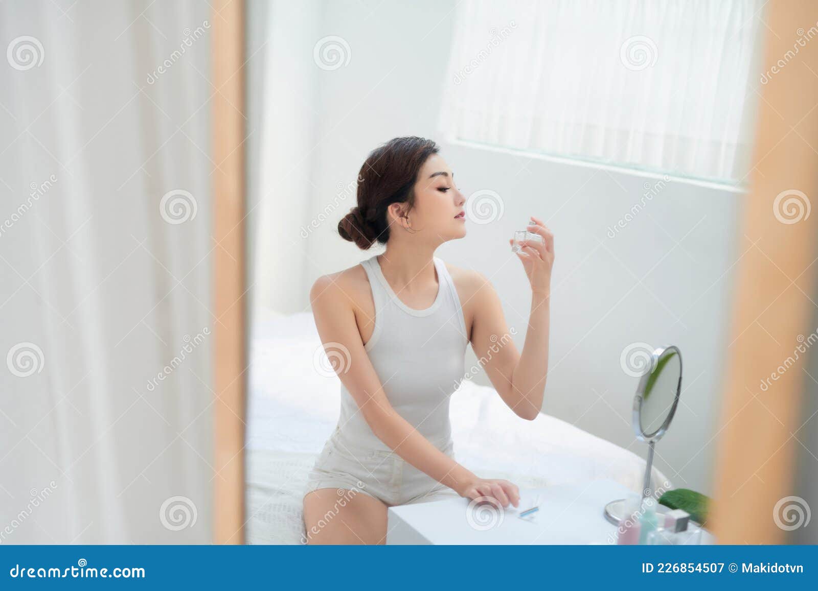Woman Sprays a Perfume from a Bottle on Her Neck Stock Image - Image of ...
