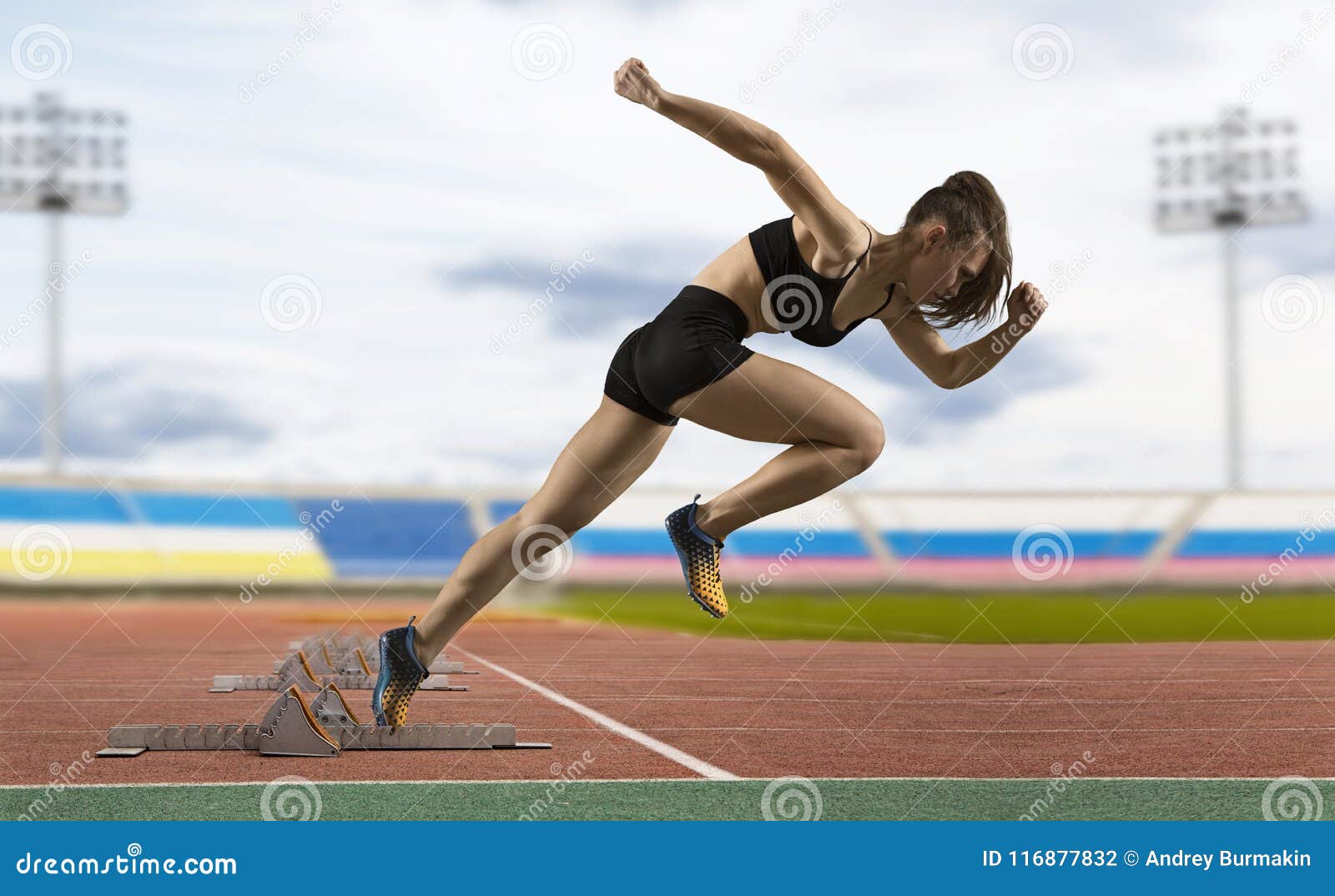 Woman Sprinter Leaving Starting Blocks on the Athletic Track Stock ...