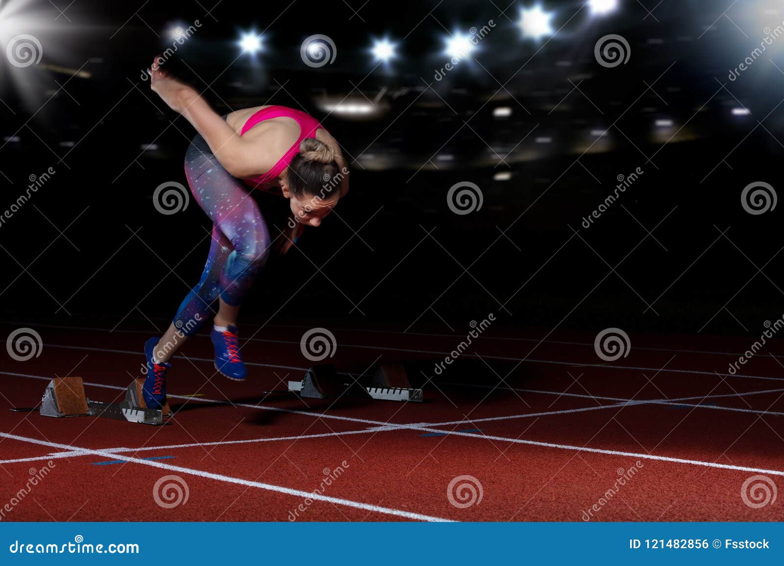 Woman Sprinter Leaving Starting Blocks on the Athletic Track. Exploding ...