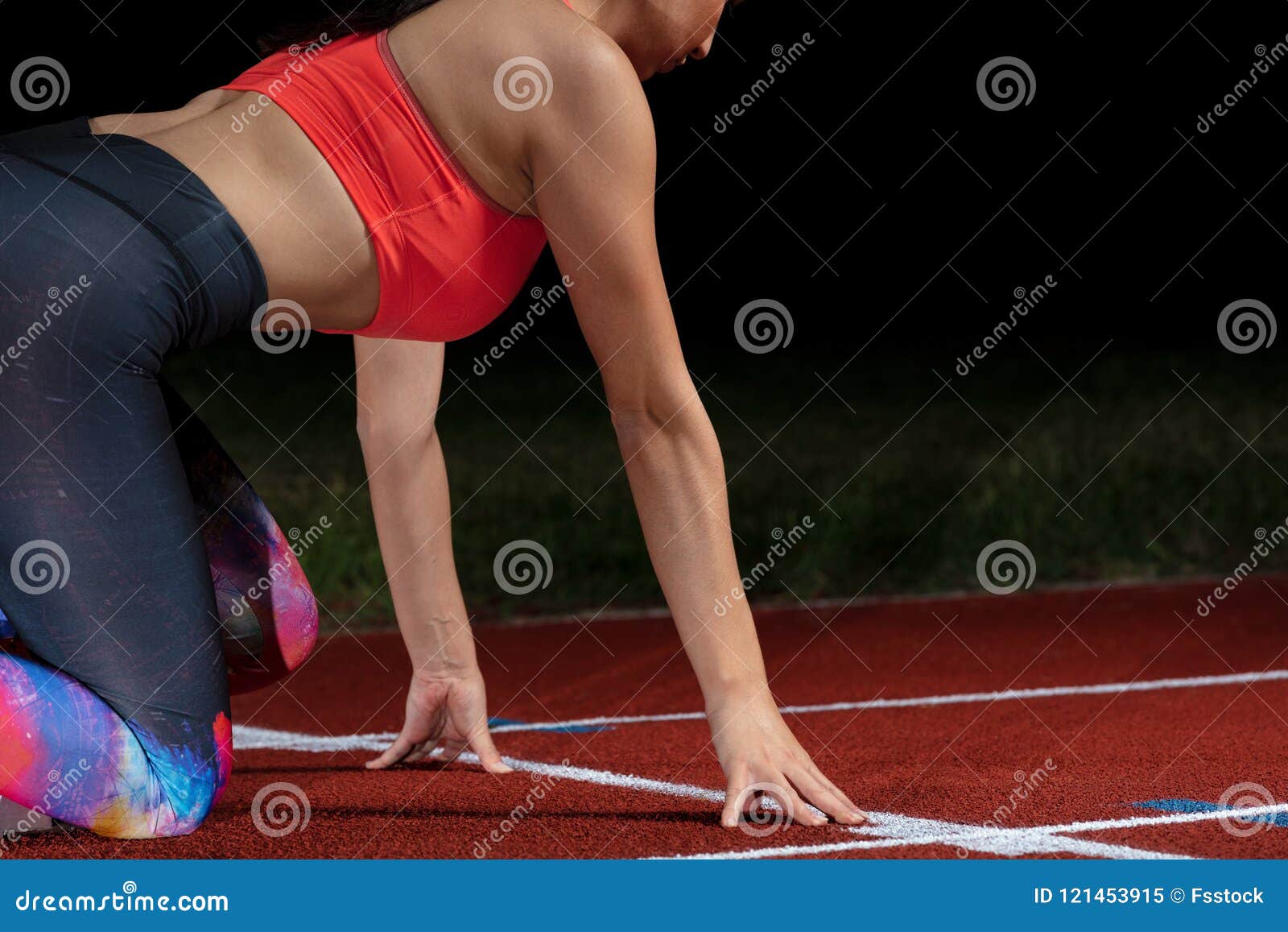 Woman Sprinter Leaving Starting Blocks on the Athletic Track. Exploding ...