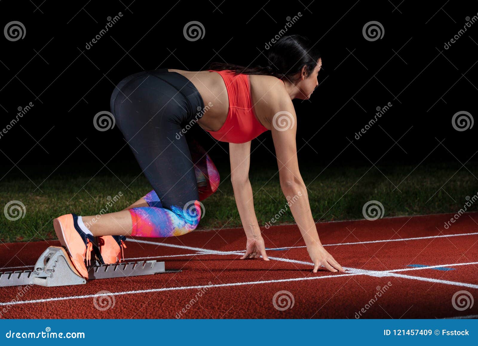 Woman Sprinter Leaving Starting Blocks on the Athletic Track. Exploding ...