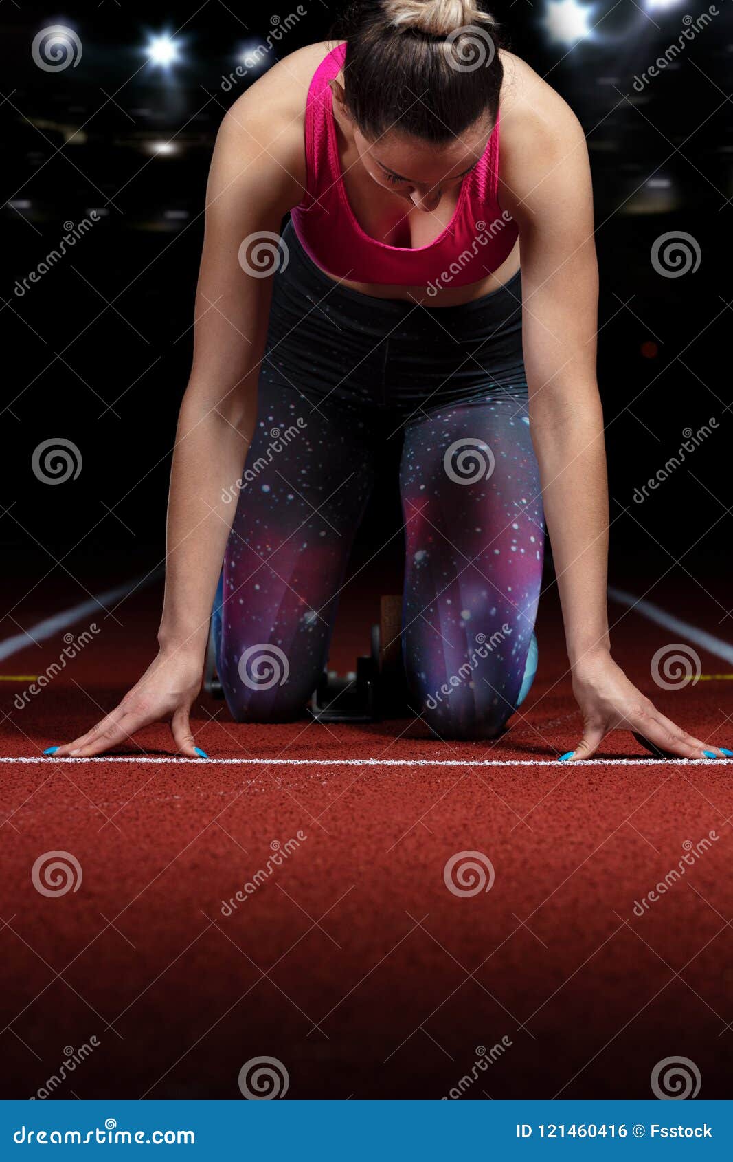 Woman Sprinter Leaving Starting Blocks on the Athletic Track. Exploding ...