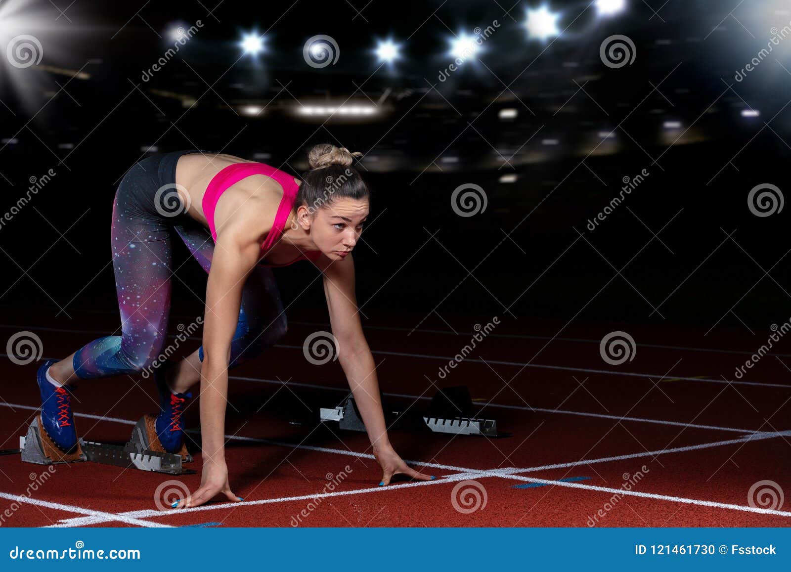 Woman Sprinter Leaving Starting Blocks on the Athletic Track. Exploding ...