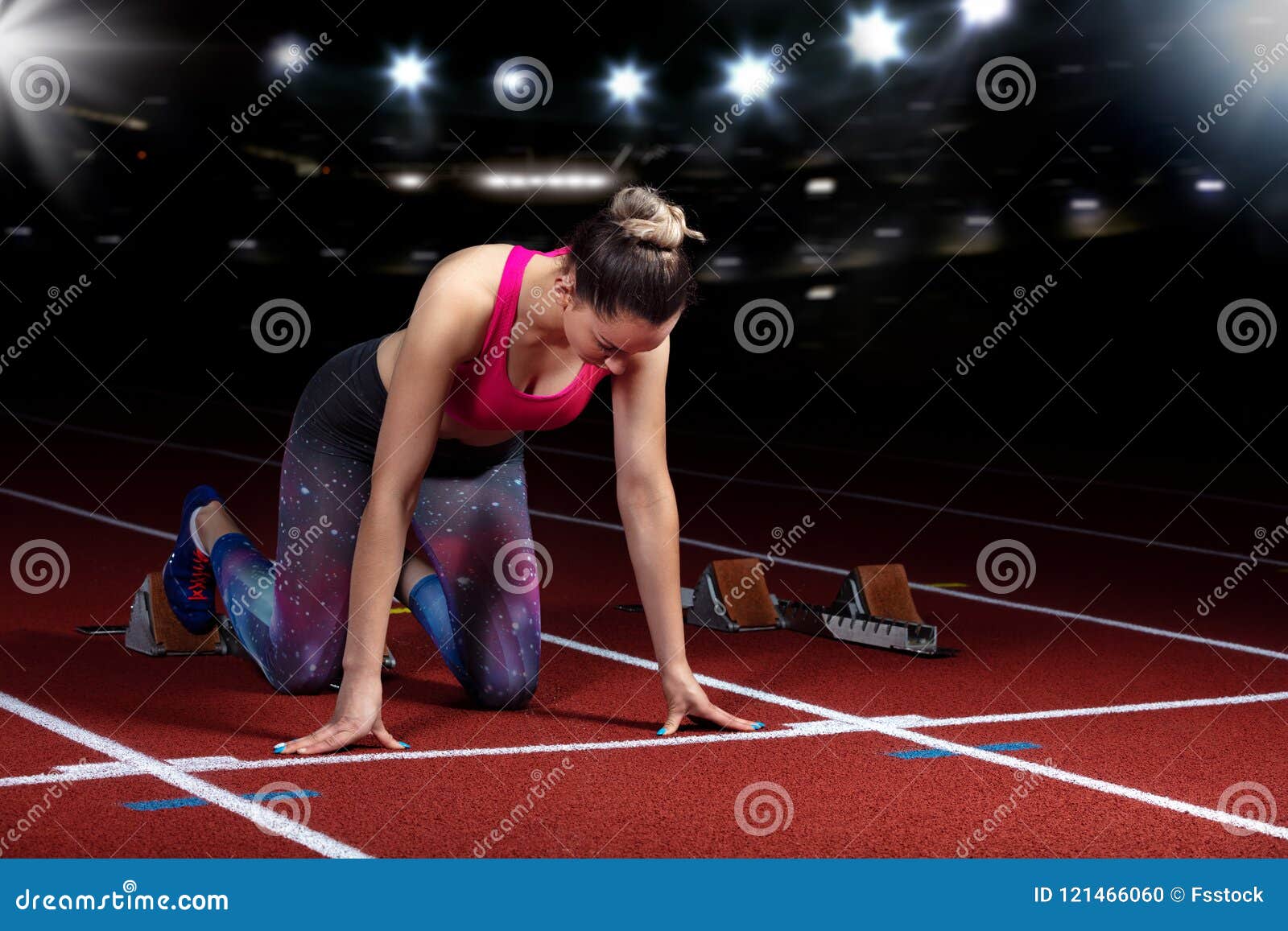 Woman Sprinter Leaving Starting Blocks on the Athletic Track. Exploding ...