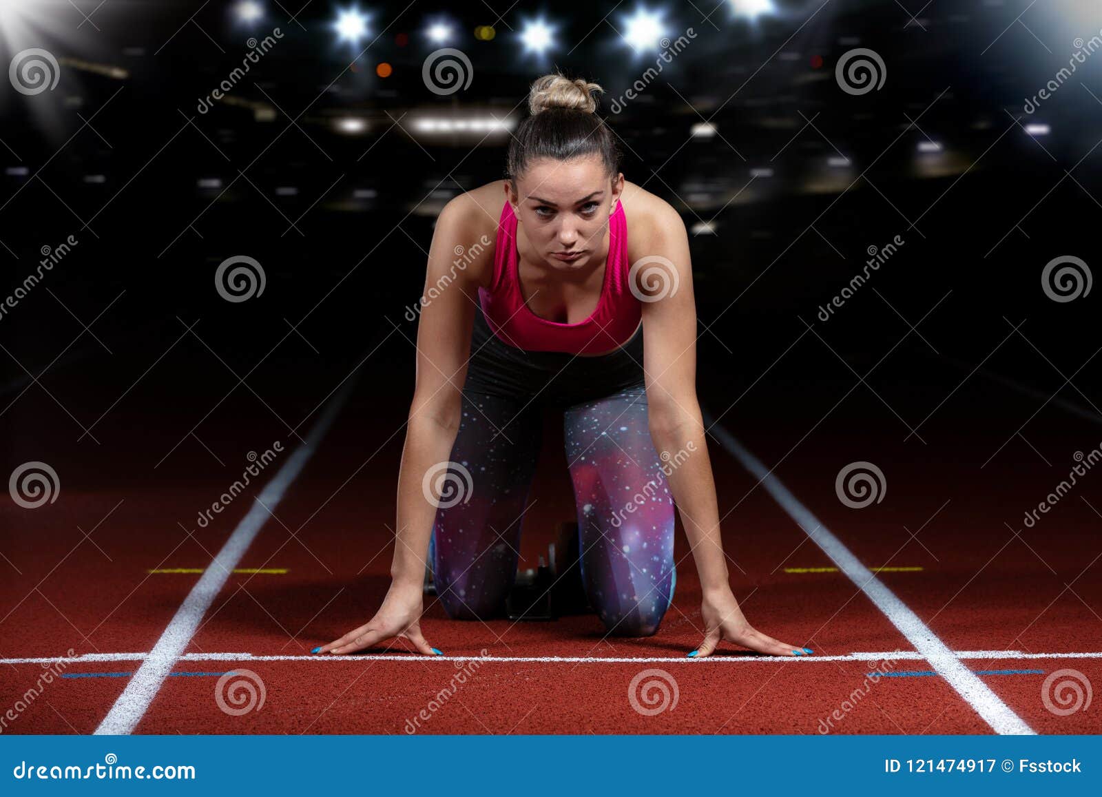 Woman Sprinter Leaving Starting Blocks on the Athletic Track. Exploding ...