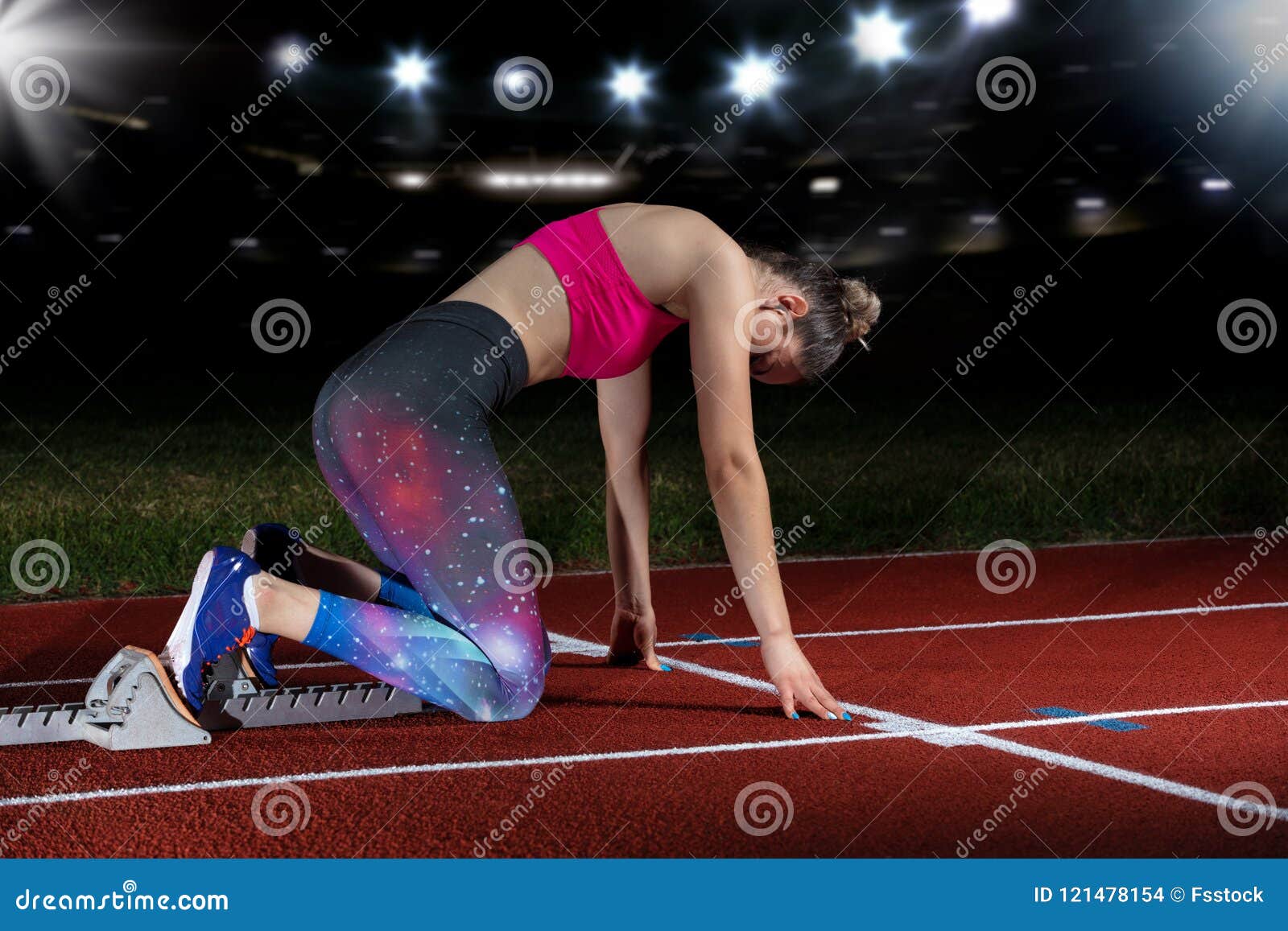 Woman Sprinter Leaving Starting Blocks on the Athletic Track. Exploding ...