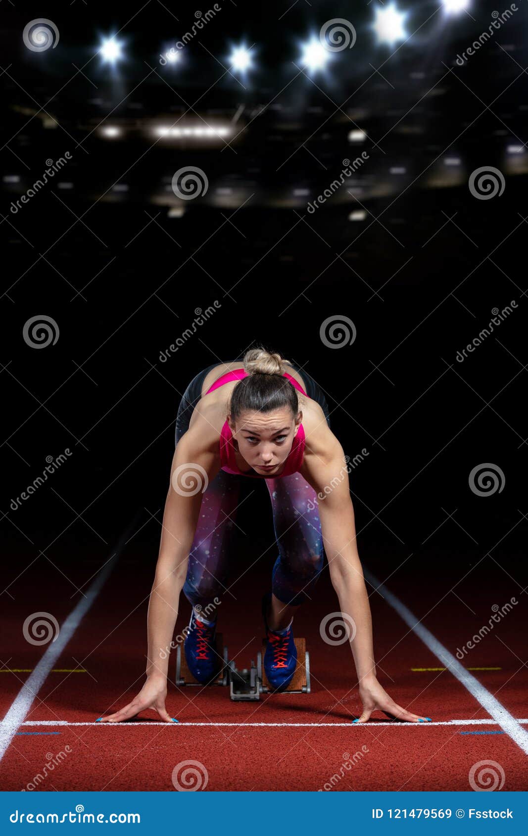 Woman Sprinter Leaving Starting Blocks on the Athletic Track. Exploding ...