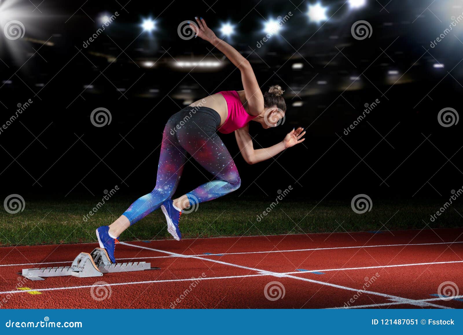 Woman Sprinter Leaving Starting Blocks on the Athletic Track. Exploding ...