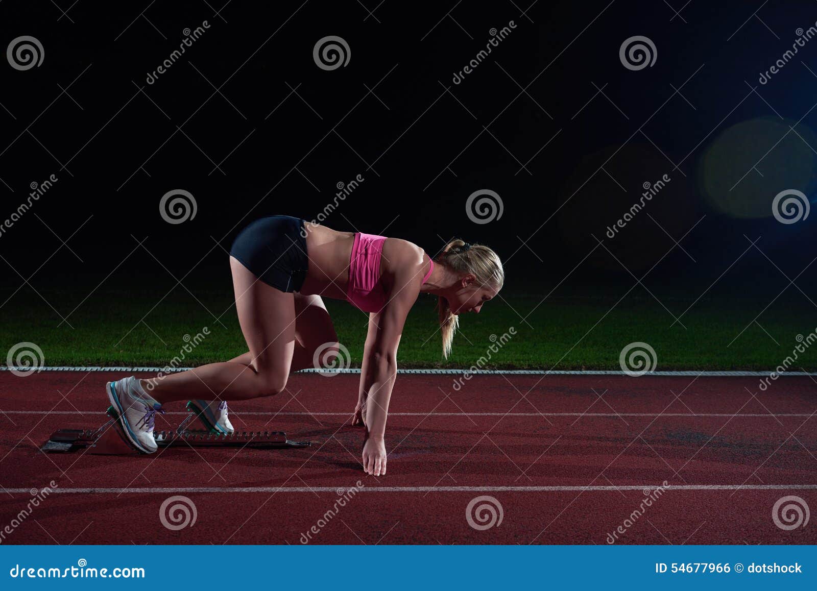 Woman Sprinter Leaving Starting Blocks Stock Photo - Image of muscular ...