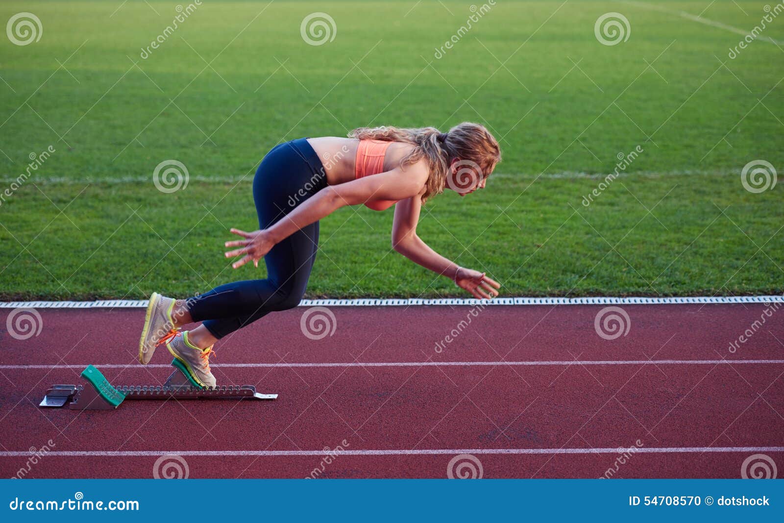 Woman Sprinter Leaving Starting Blocks Stock Photo - Image of athlete ...