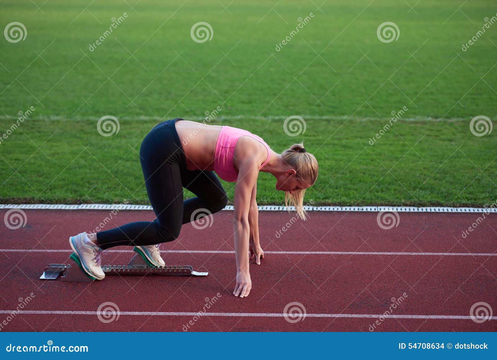 Woman Sprinter Leaving Starting Blocks Stock Photo - Image of adult ...
