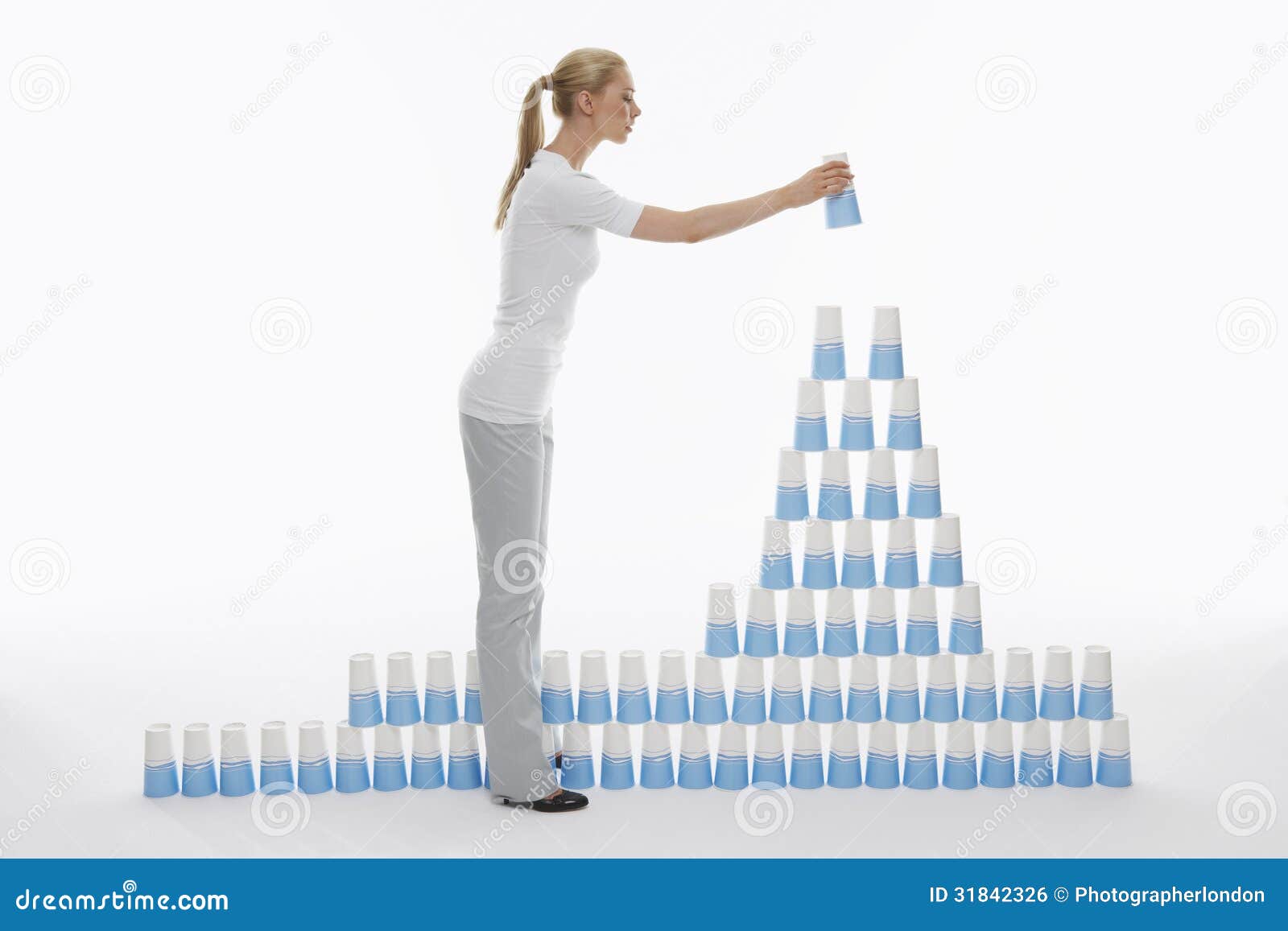Woman Stacking Plastic Cups Into Pyramid Royalty-Free Stock Image ...