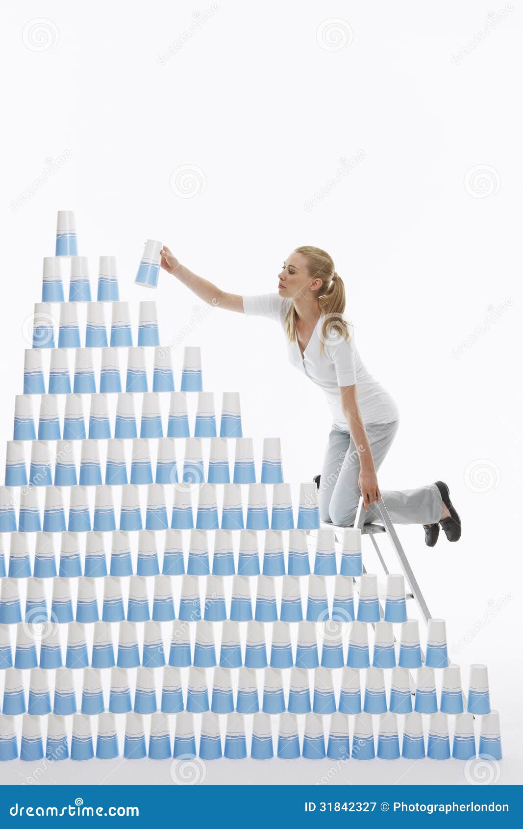 Woman Stacking Plastic Cups Into Pyramid Royalty-Free Stock Photo ...