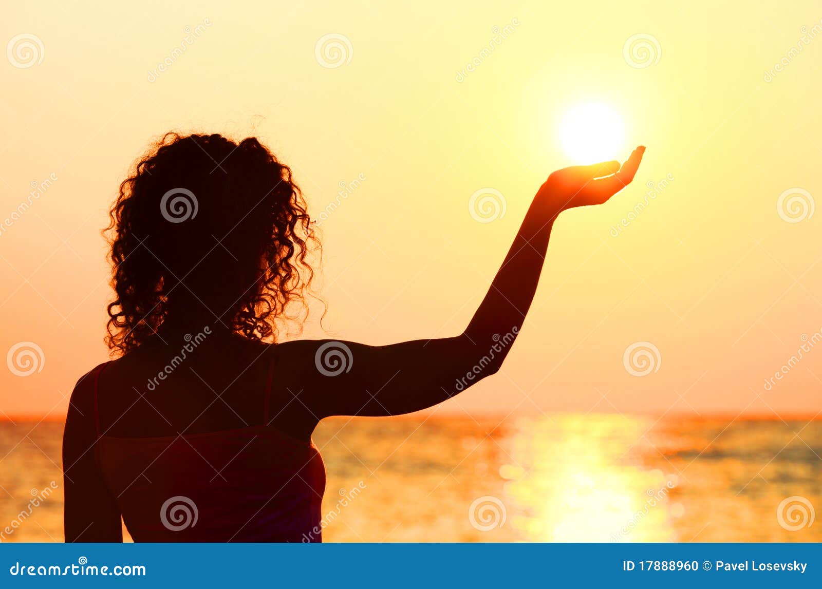 Woman Standing on Beach, Holding Sun in Hand Stock Photo - Image of ...