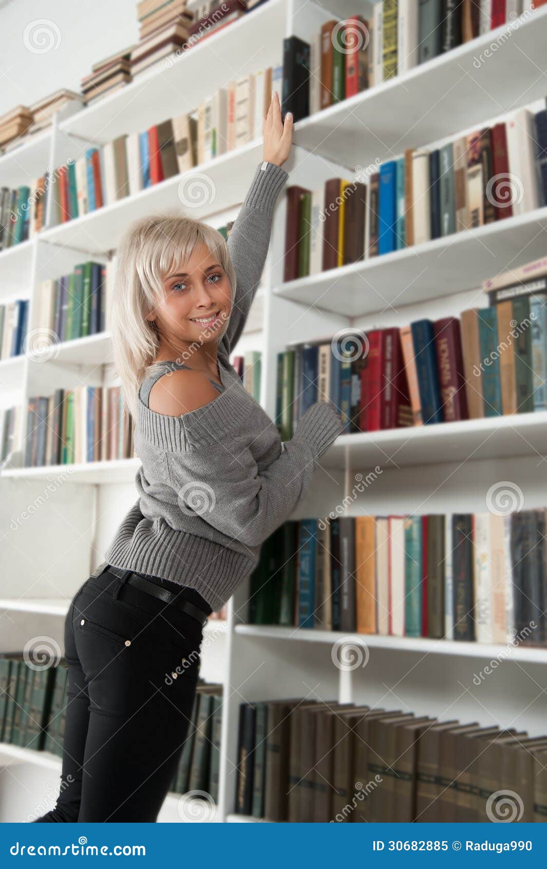 Woman Standing at Bookshelf Stock Image - Image of young, indoors: 30682885