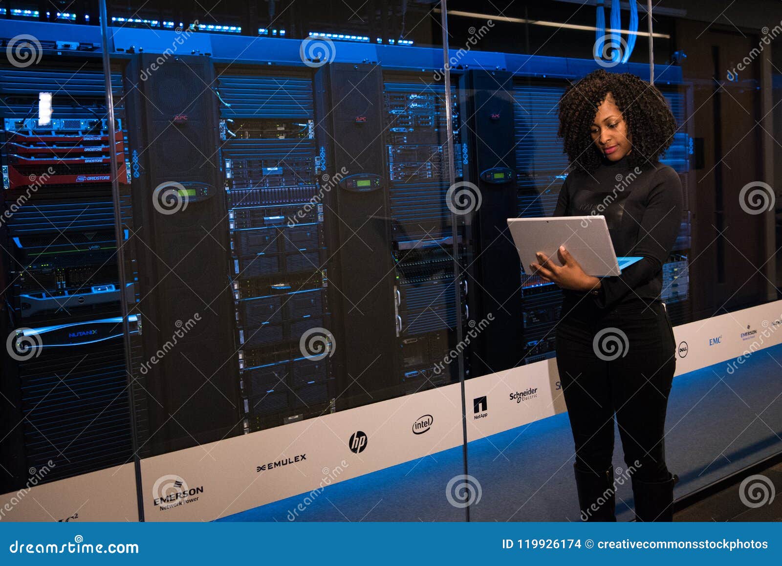 Woman Standing While Carrying Laptop Picture. Image: 119926174