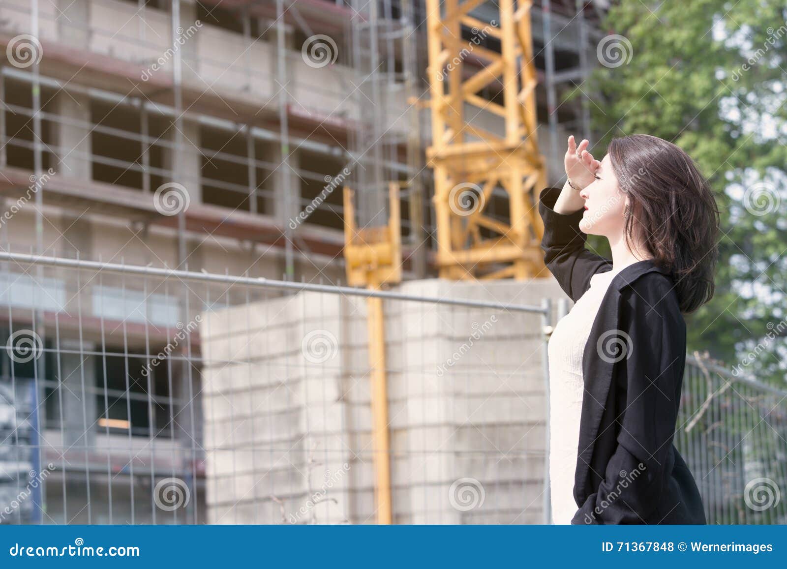 Woman Standing at Construction Site and Looking at Building Stock Photo ...