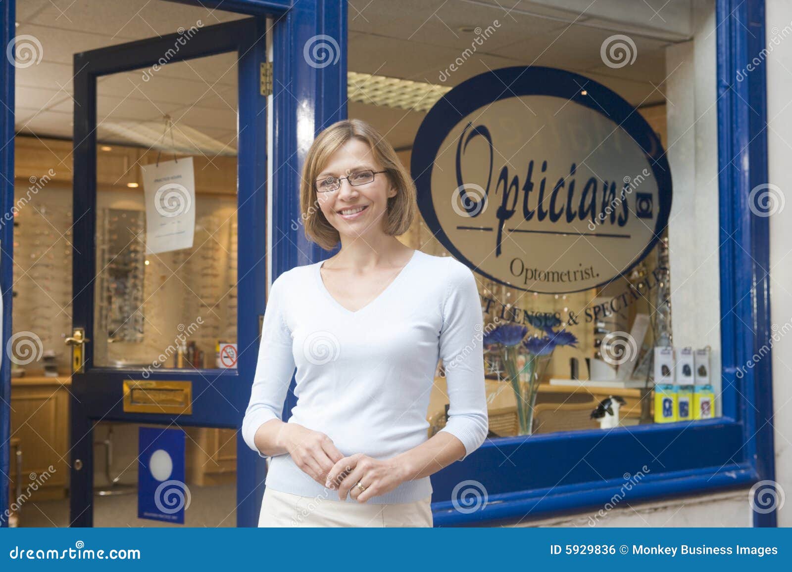 Woman Standing at Front Entrance of Opticians Stock Photo - Image of ...