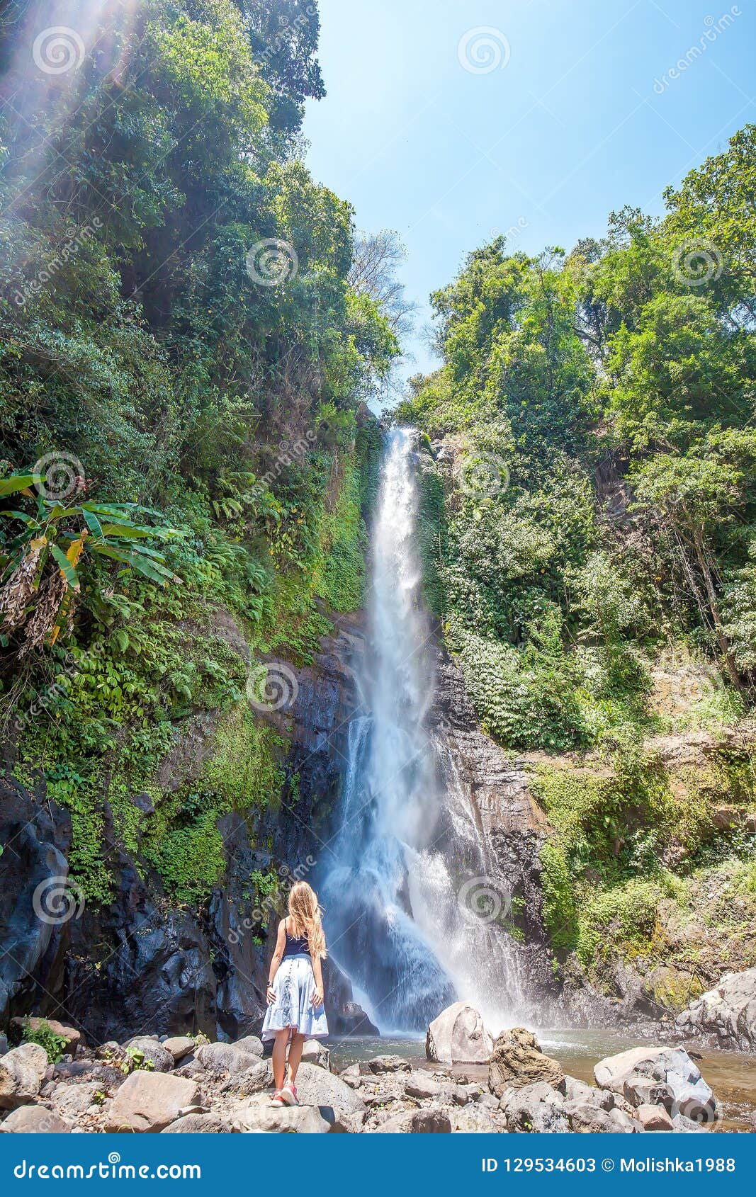 Woman Standing in Front of Gitgit Waterfall Stock Image - Image of ...