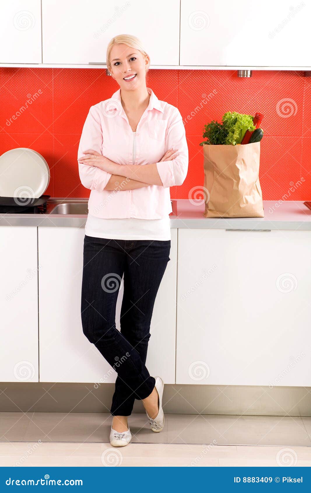 Woman standing in kitchen stock image. Image of vegetables - 8883409