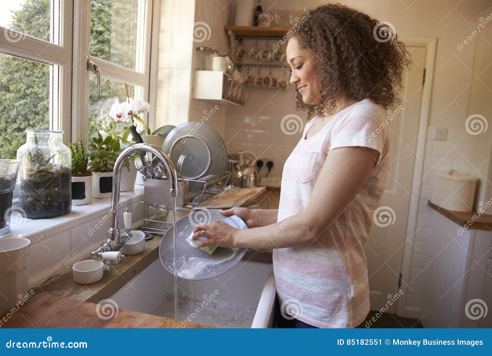 Woman Standing at Kitchen Sink Washing Up Stock Image - Image of ...