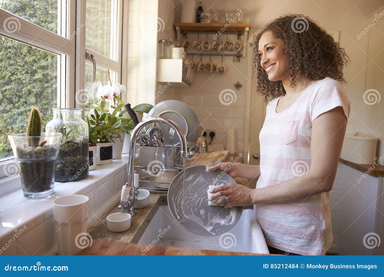 Woman Standing at Kitchen Sink Washing Up Stock Photo - Image of ...