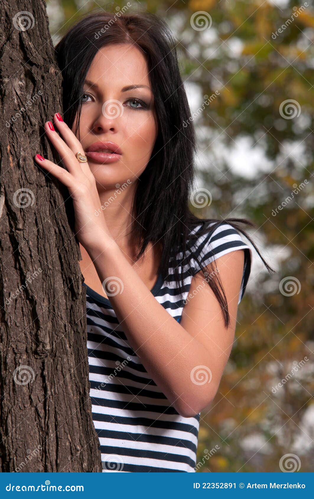Woman standing near a tree stock image. Image of leaves - 22352891