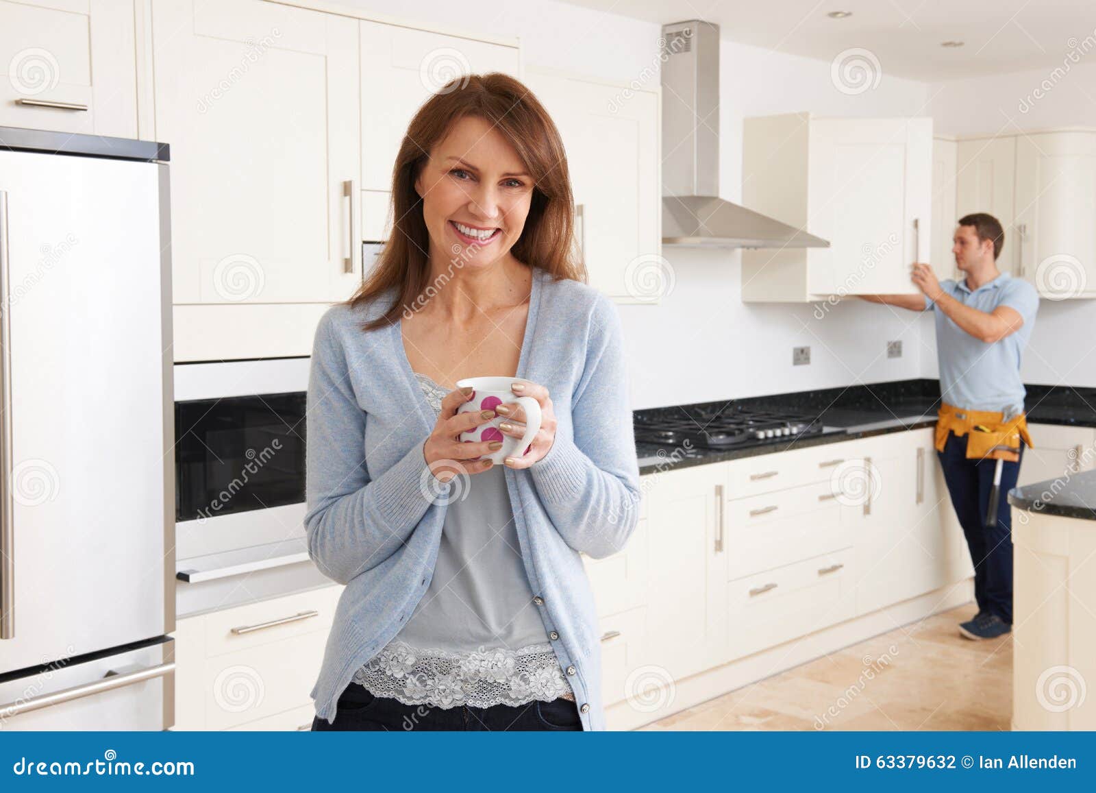 Woman Standing in New Luxury Fitted Kitchen Stock Photo - Image of ...