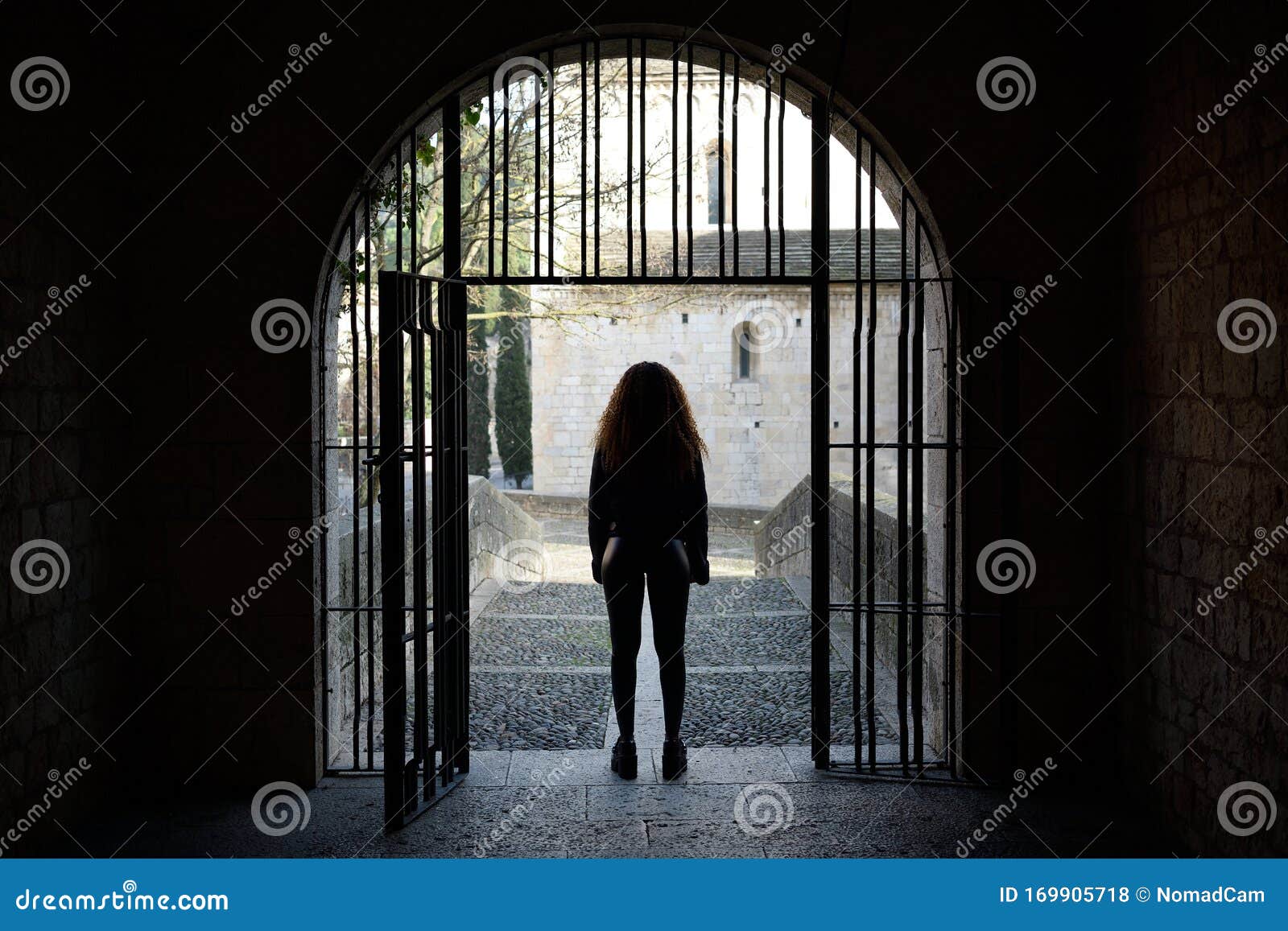 Woman Standing in an Open Iron Gate Facing Outwards Stock Photo - Image ...