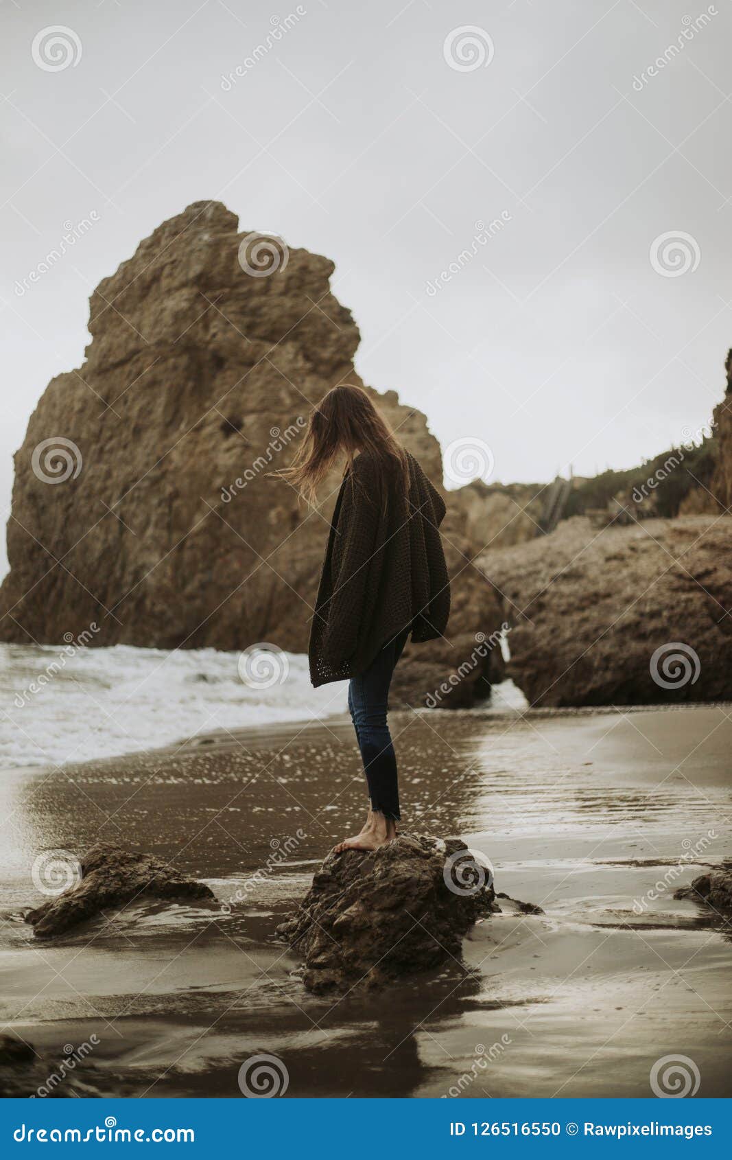 Woman Standing on a Rock at the Beach Stock Photo - Image of brunette ...