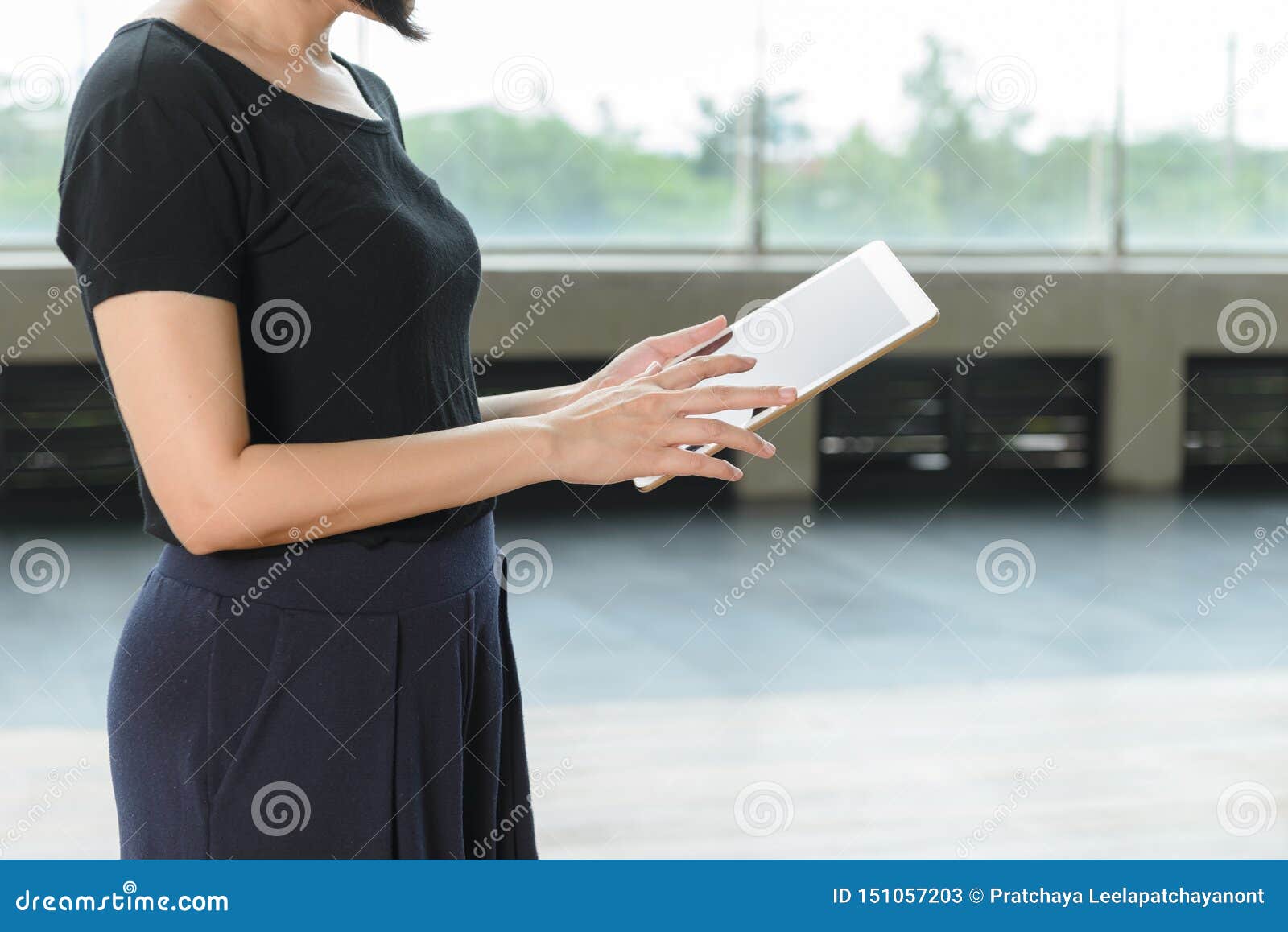 Woman Standing and Using a Tablet Computer in Building Stock Image ...