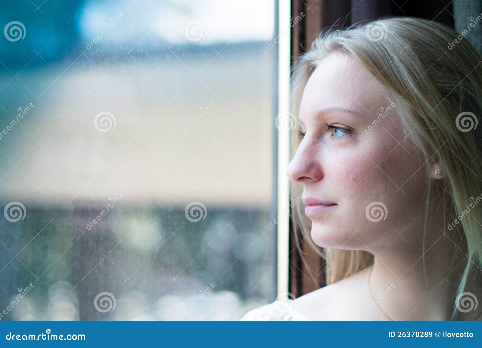 Woman Standing by a Window Looking Outside Stock Image - Image of ...
