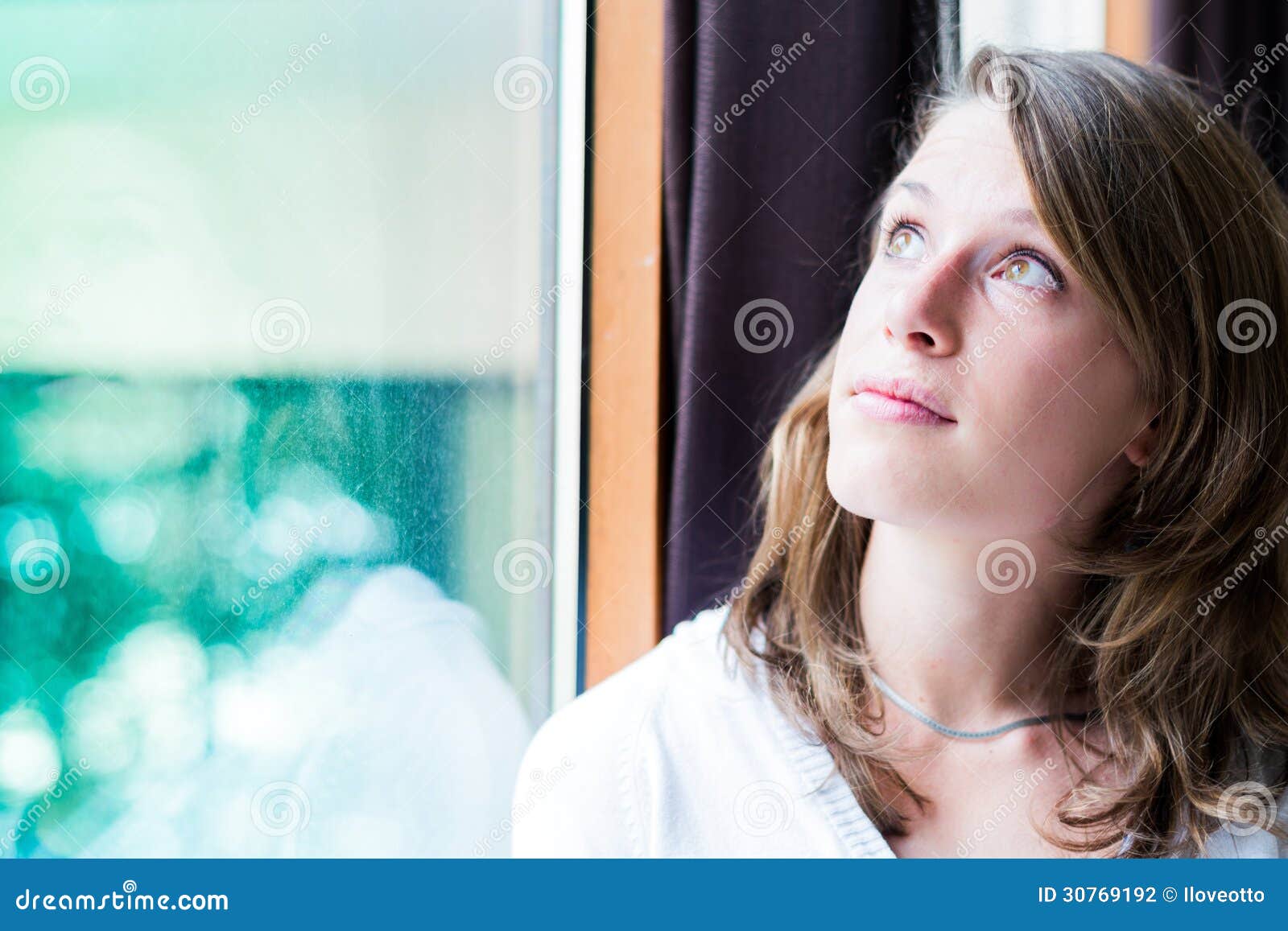 Woman standing by a window stock photo. Image of home - 30769192