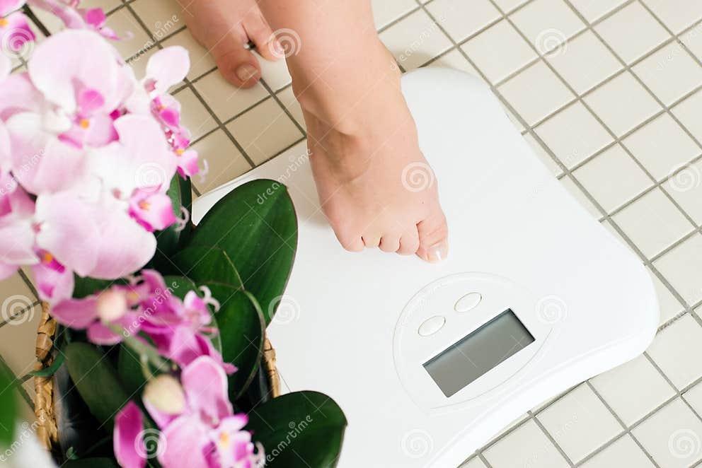 Woman stepping on scale stock image. Image of loss, weight - 12385213