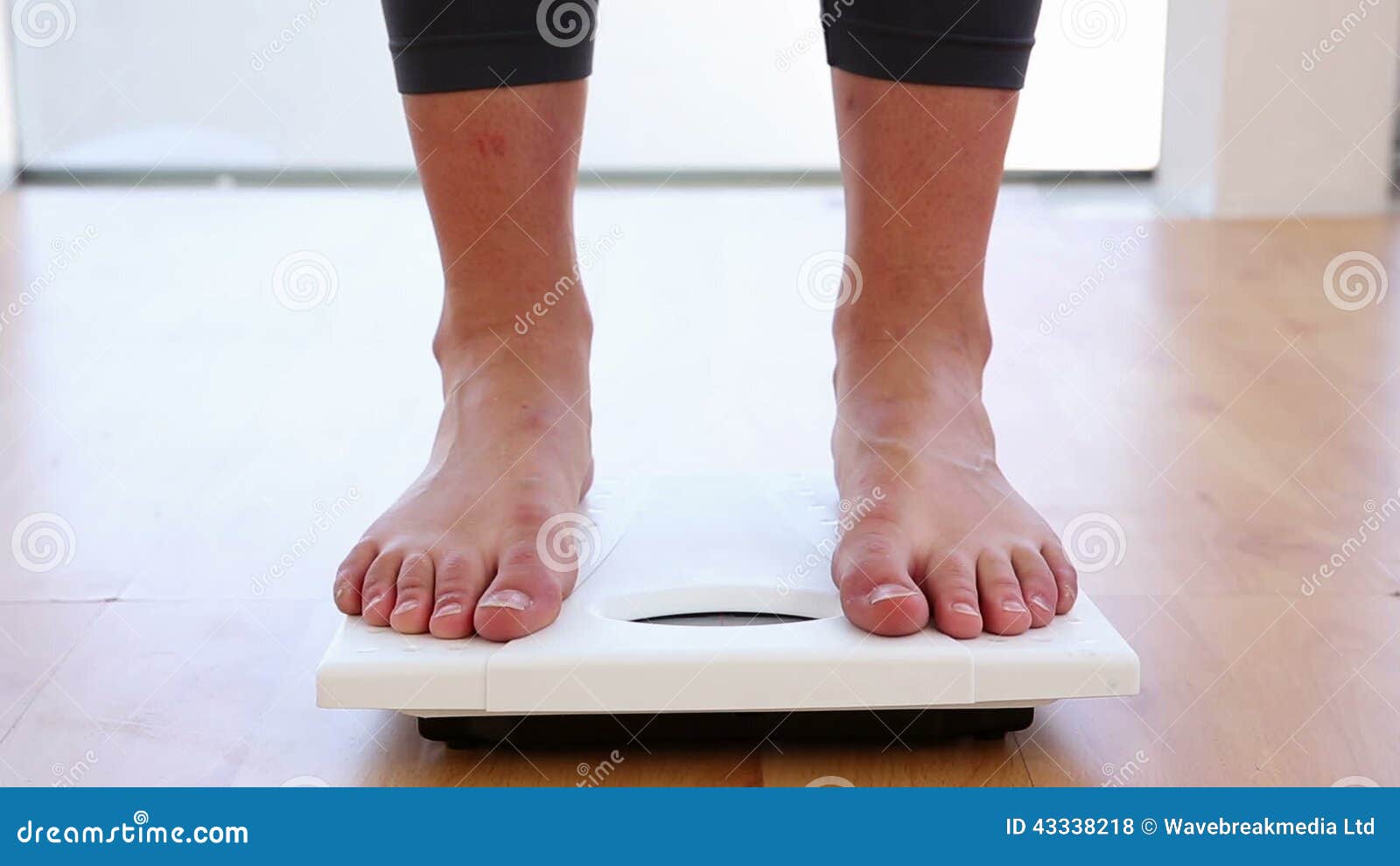 Woman stepping on scales stock footage. Video of physical - 43338218