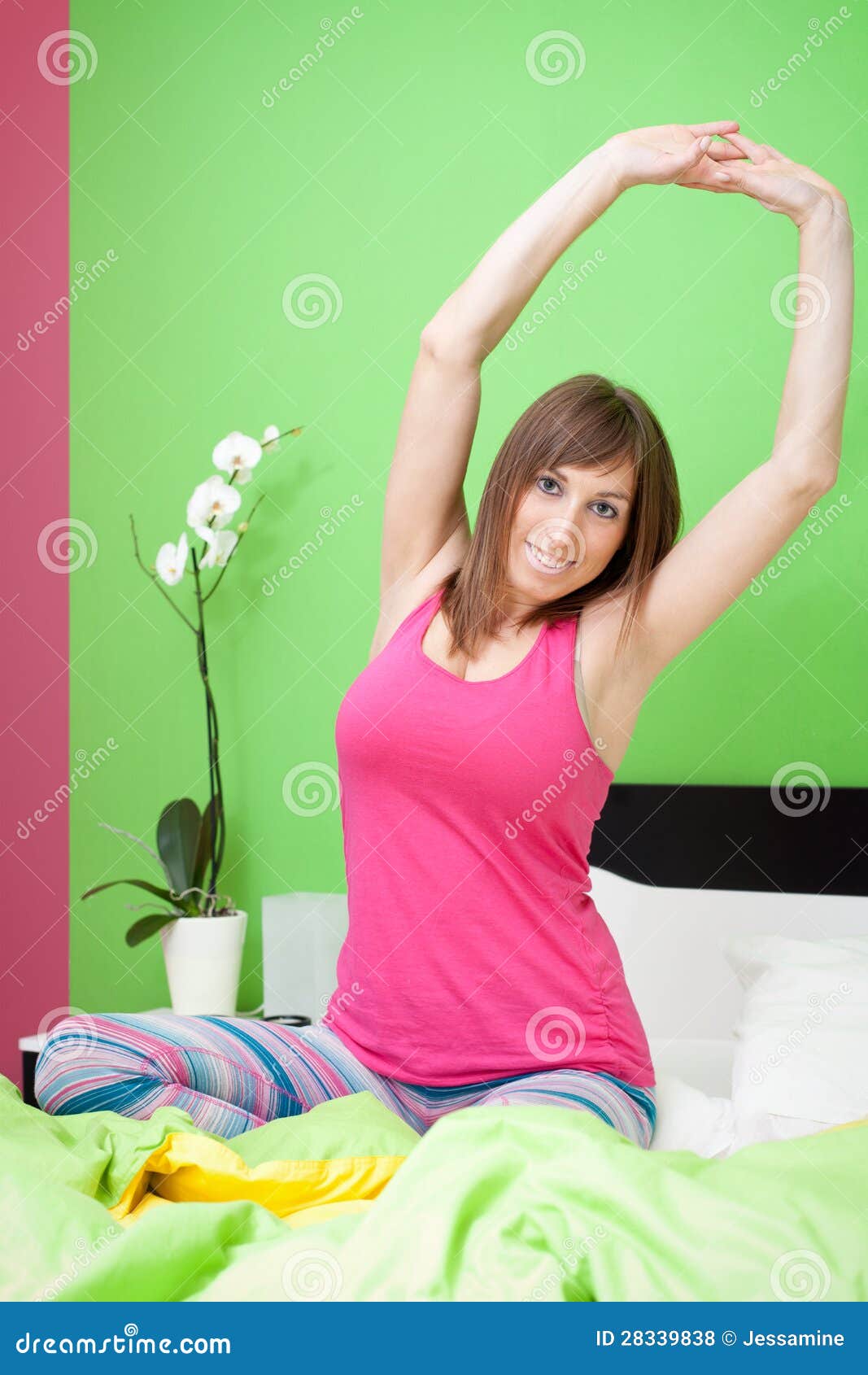 Woman stretching in bed stock photo. Image of arms, pyjama - 28339838