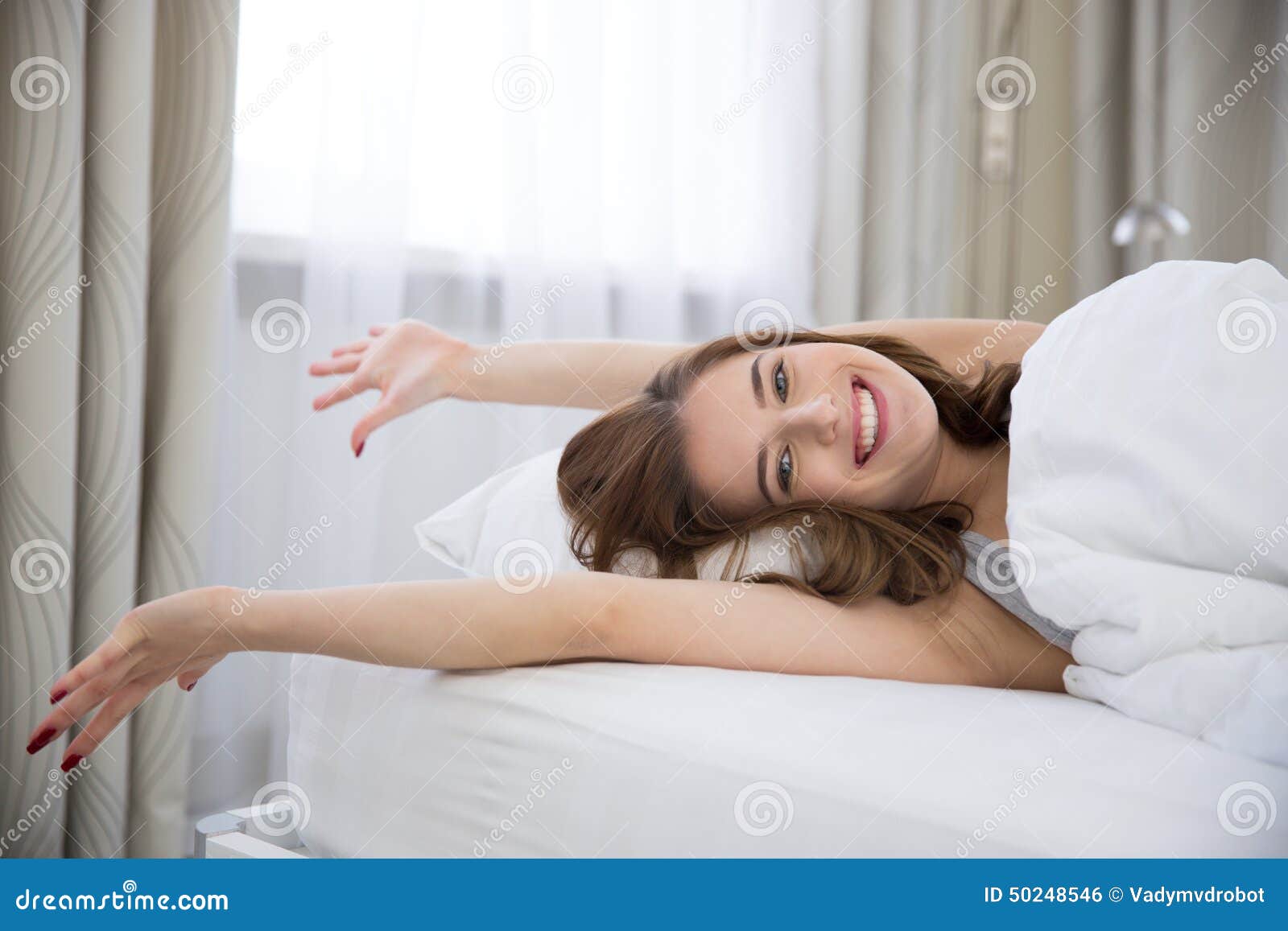 Woman Stretching on the Bed Stock Photo - Image of attractive, portrait ...