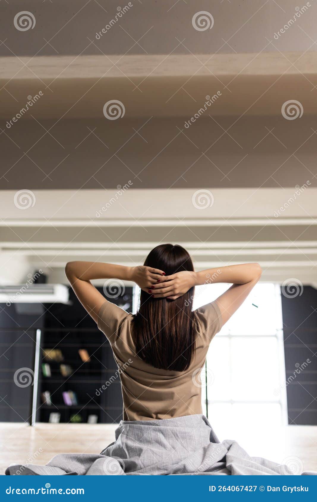 Young Woman Stretching in Bed after Waking Up, Back View Stock Image ...