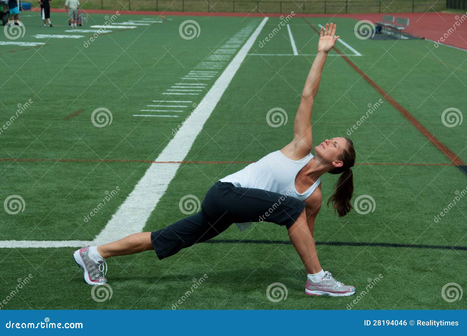 Woman Stretching on Field stock photo. Image of attractive - 28194046