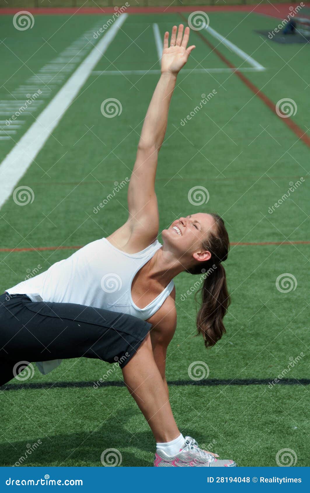 Woman Stretching on Field stock photo. Image of attractive - 28194048