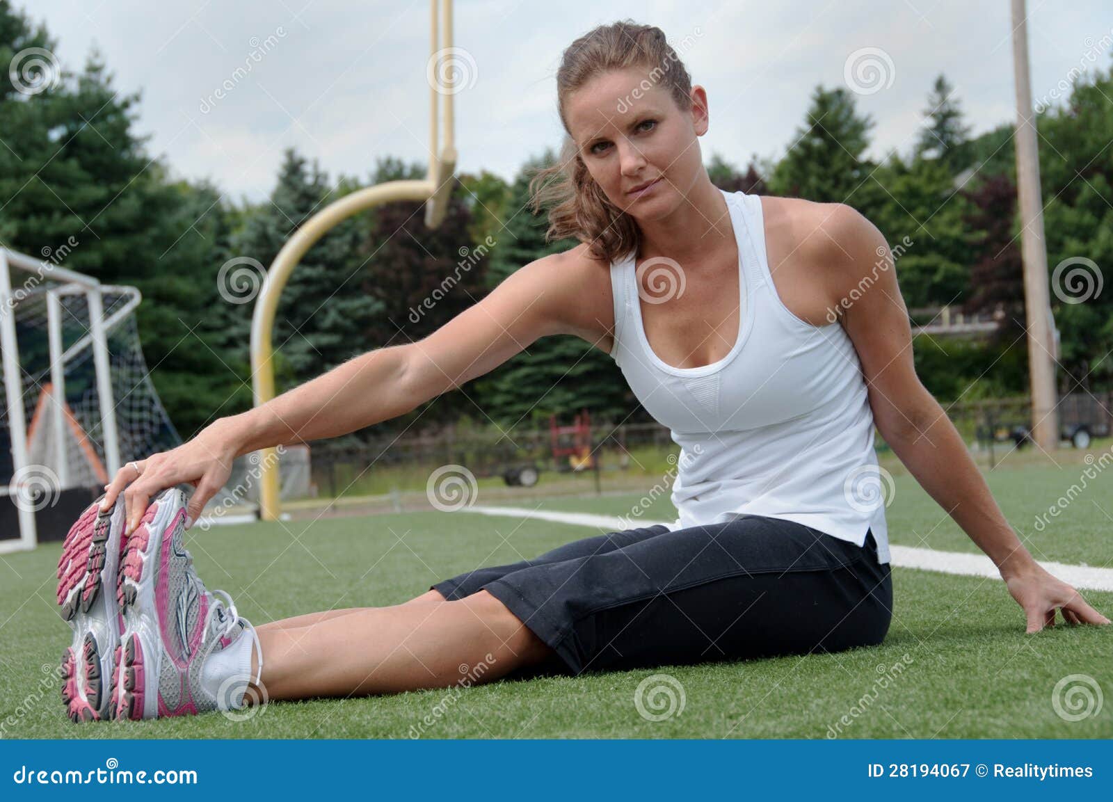 Woman Stretching on Field stock image. Image of girl - 28194067