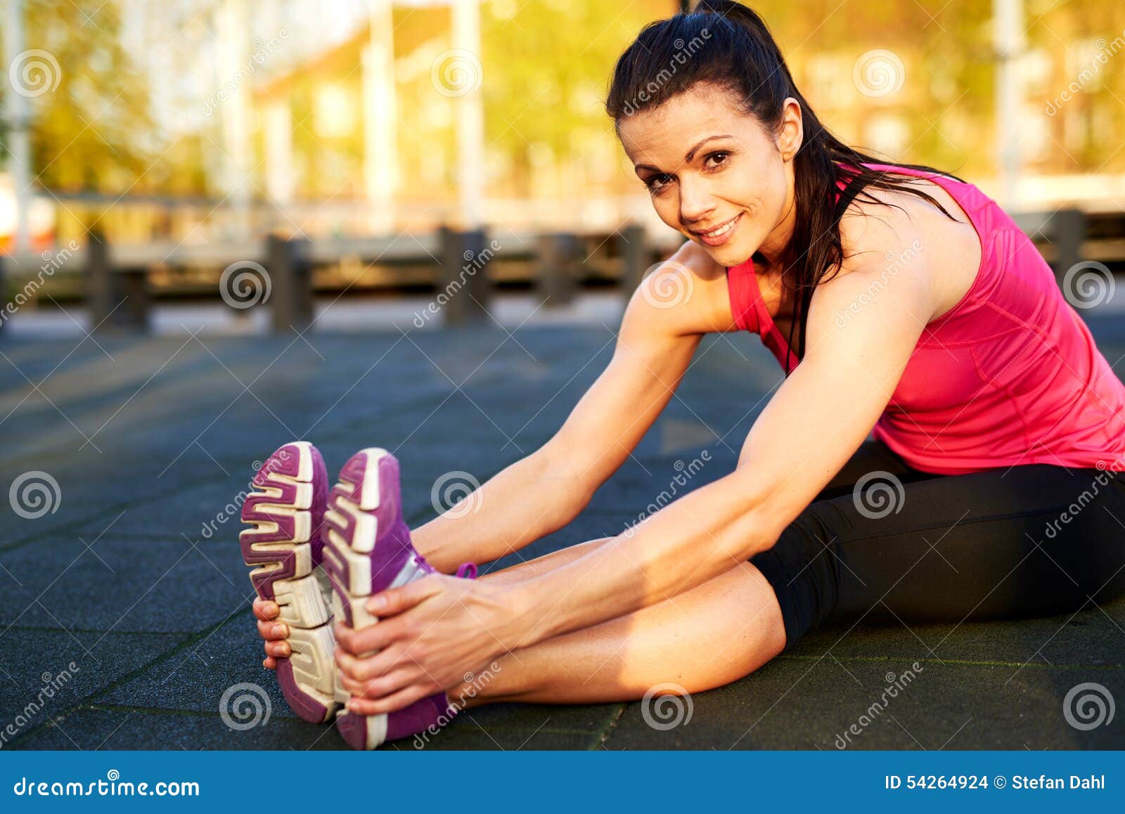 Woman Stretching Hamstrings and Smiling. Stock Photo - Image of ...
