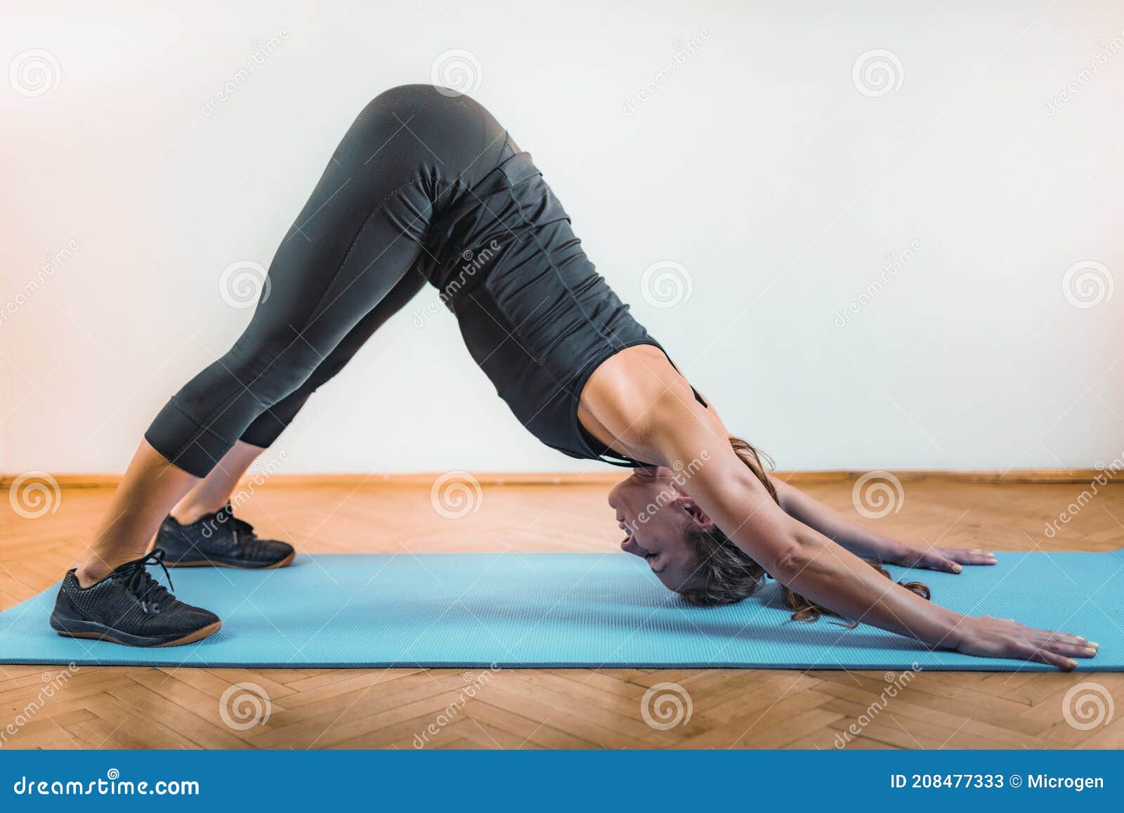 Woman Stretching Indoors after High Intensity Interval Training Stock ...